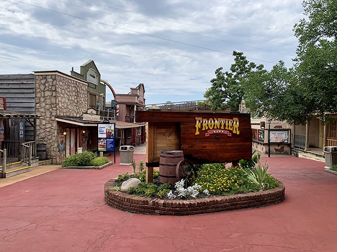The Western-themed entrance plaza welcomes visitors with rustic charm and a wooden sign that promises adventures straight out of the frontier days.