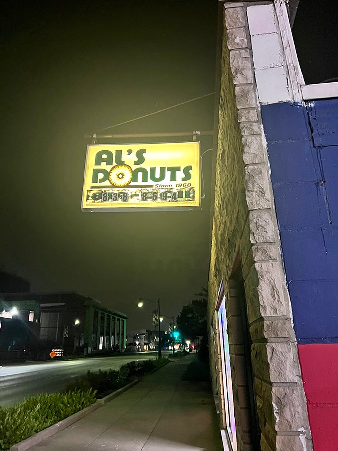 Al's Donuts sign at night: Glowing like a beacon of hope since 1960. Al's sign has guided hungry night owls for generations.
