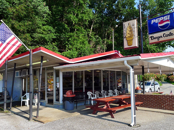 Burger Carte's red roof and ice cream sign stand like a beacon of hope for hungry travelers. The picnic tables practically whisper, "Stay awhile."