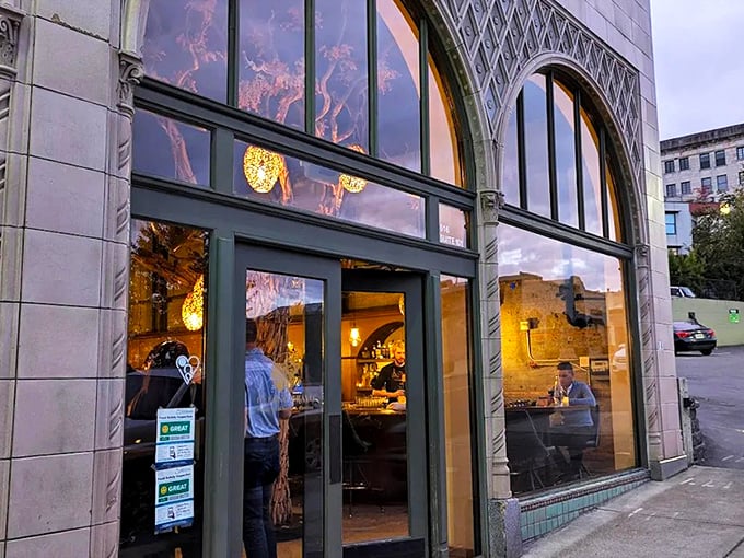 Cuerno Bravo Steakhouse (Tacoma): Warm golden light spills from arched windows, promising Latin-inspired steak magic within this historic Tacoma gem.