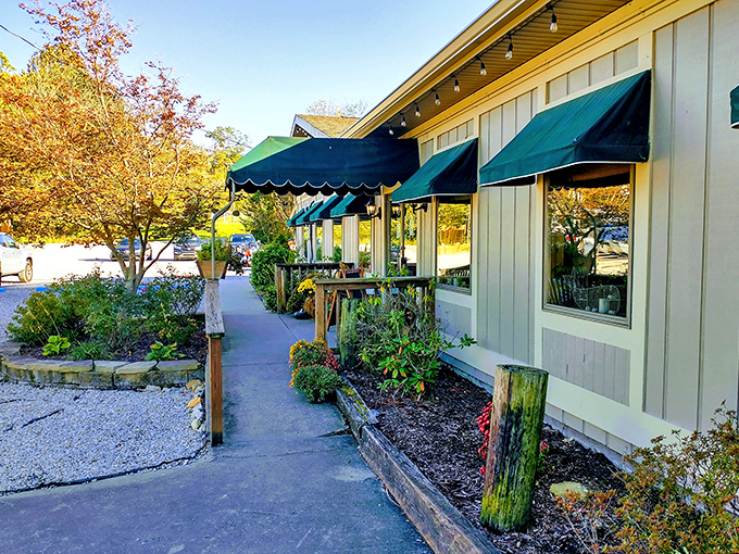 The Lake House's garden pathway feels like the perfect prelude to a seafood feast. Those green awnings whisper promises of fresh catches.