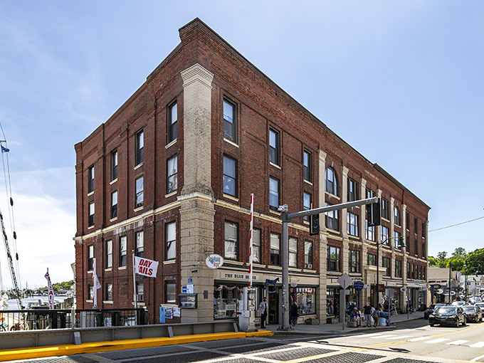 Stately brick buildings in Mystic welcome you to explore local shops and vibrant storefronts nestled right along the scenic waterfront.