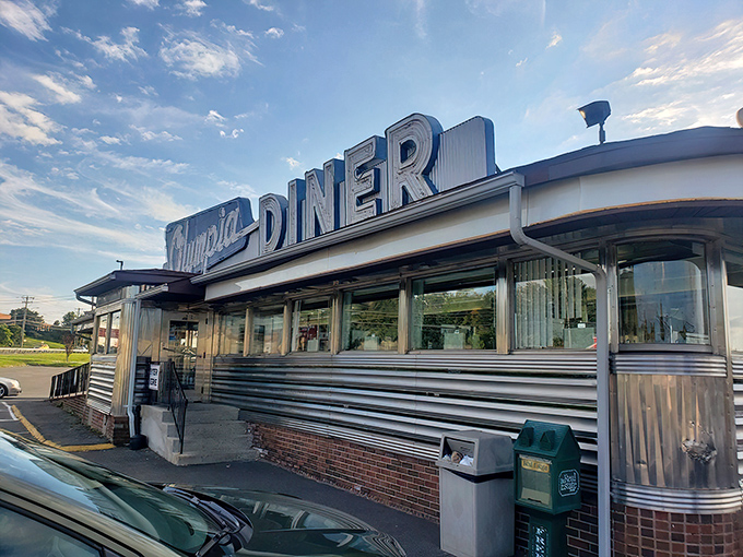 Olympia Diner's gleaming stainless steel exterior shines like a time capsule from the golden age of roadside dining. 