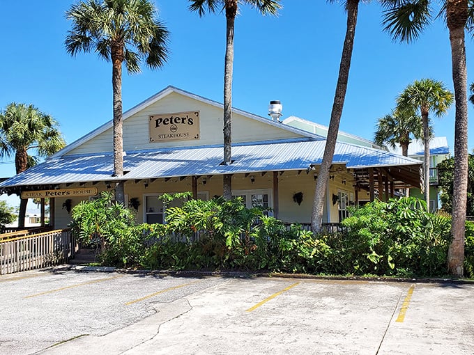 Peter's Steak House embraces old Florida charm with its sunny yellow exterior and palm trees standing guard like culinary sentinels.
