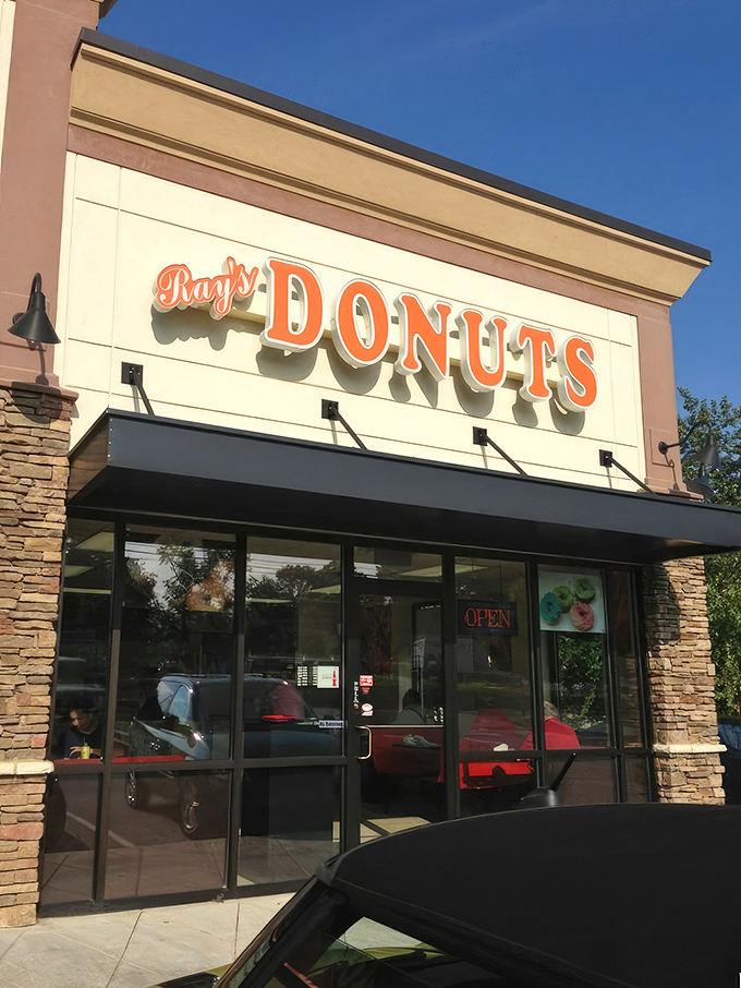 Ray's bold orange sign glows like a beacon of hope for those in need of a serious donut intervention.