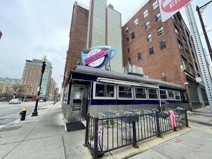 South Street Diner's iconic coffee cup sign hovers above Boston like a beacon for breakfast lovers seeking comfort at any hour.