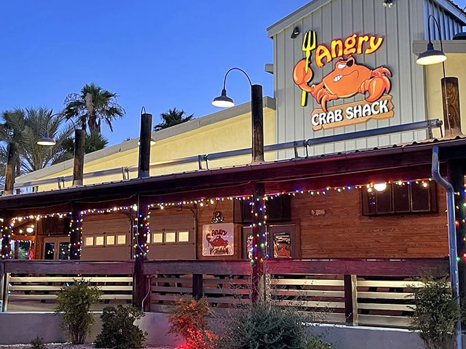 As night falls, Angry Crab Shack lights up like a beacon for seafood lovers. The neon crab knows what you're craving!