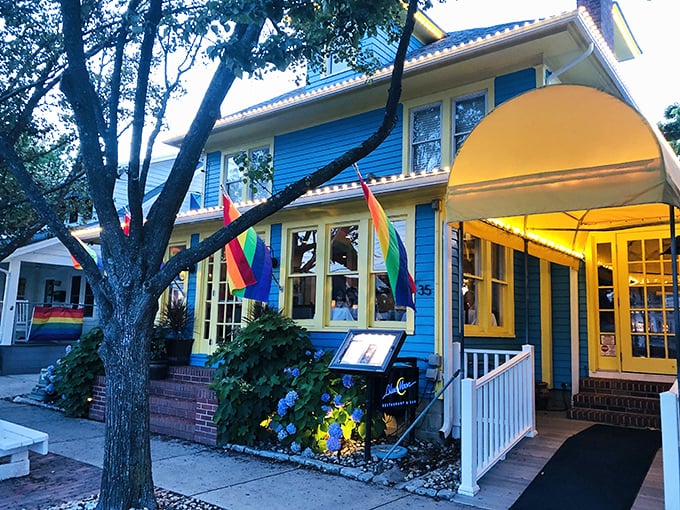 Rainbow flags flutter outside this cheerful blue Victorian, where the Blue Moon's sunny yellow trim promises a celebration for all who enter.