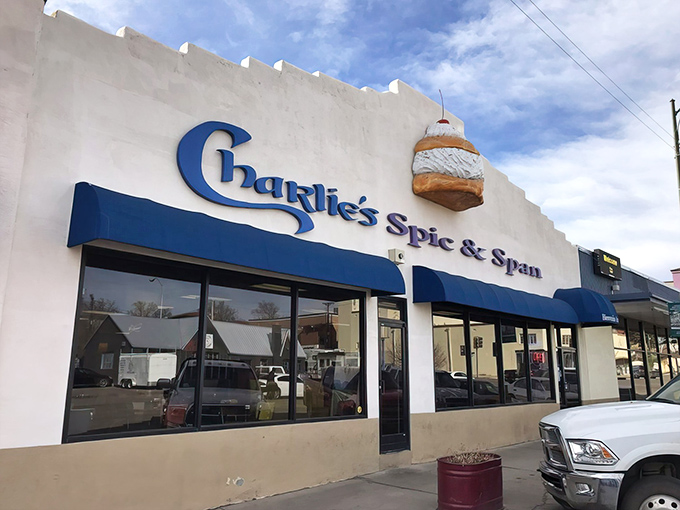 The blue awnings of Charlie's are like a beacon for breakfast lovers. That cinnamon roll sign isn't just decoration &ndash; it's a promise!