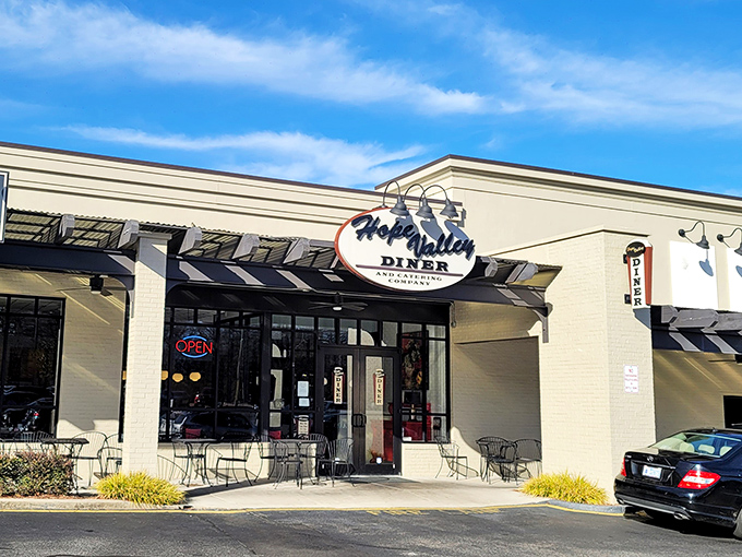 Morning sunshine hits the Hope Valley Diner sign, nature's spotlight on a place where coffee cups never stay empty.