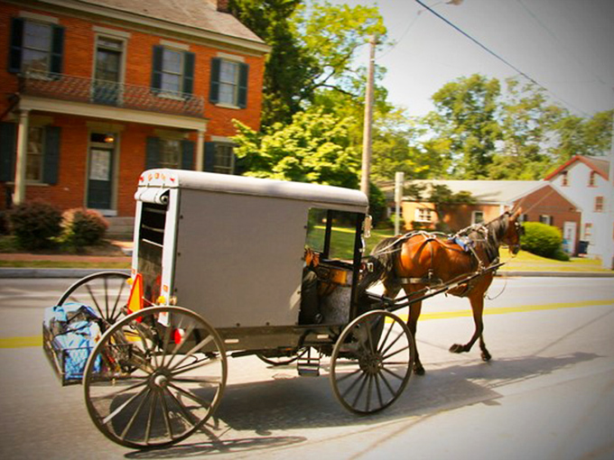 An Amish buggy rolls through Lancaster County, where retirement moves at a pace that lets you actually enjoy it.