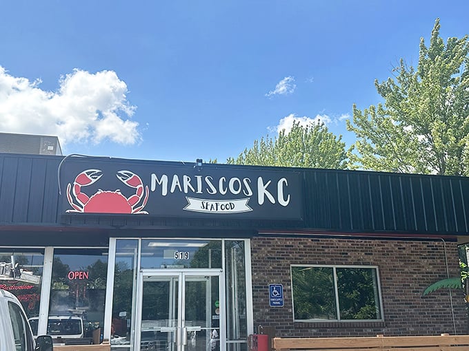 That bright red crab on the sign isn't just showing off—it's advertising the ocean of flavor waiting inside Mariscos KC.