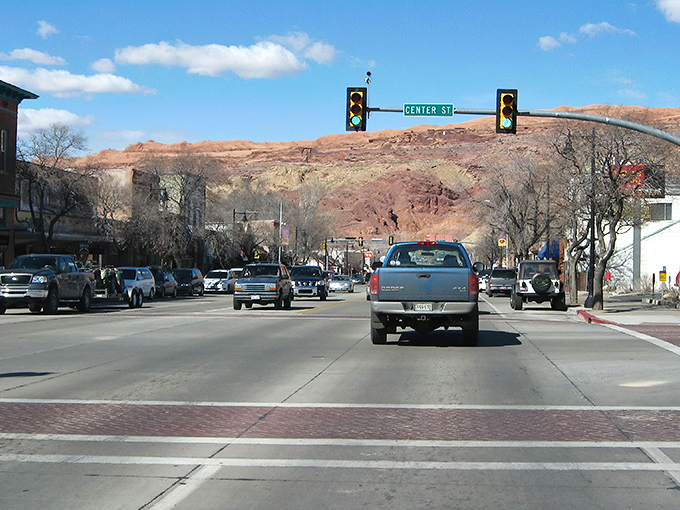 Springdale's main drag offers the ultimate backdrop: massive red cliffs that make even traffic lights look majestic.