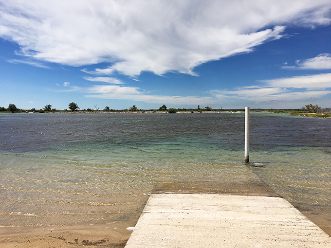 That gentle slope into clear blue water isn't a mirage. Nature's swimming pool sits patiently waiting in western Oklahoma's unexpected paradise.