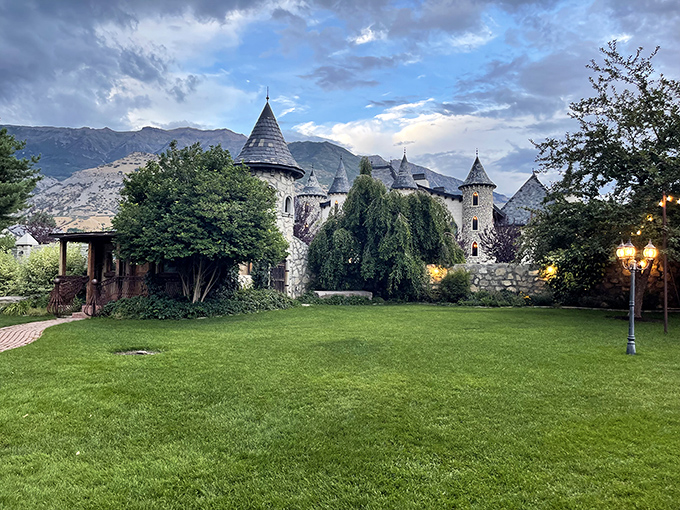 The castle's sprawling lawn invites barefoot wandering while dramatic clouds play across mountain peaks&mdash;nature's own theatrical backdrop for this architectural gem.