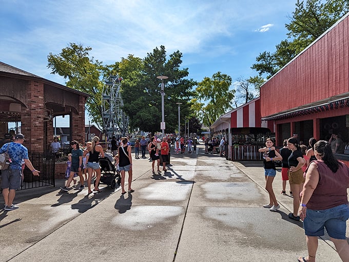 Main midway magic! Where families stroll between classic attractions under open skies, creating memories that outlast any smartphone battery.