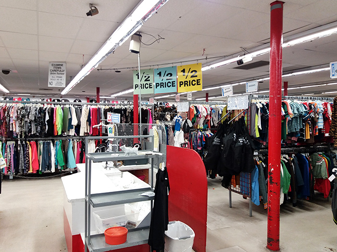 Half-price paradise awaits inside, where fluorescent lighting illuminates a landscape of possibilities and those signature red columns stand sentinel.