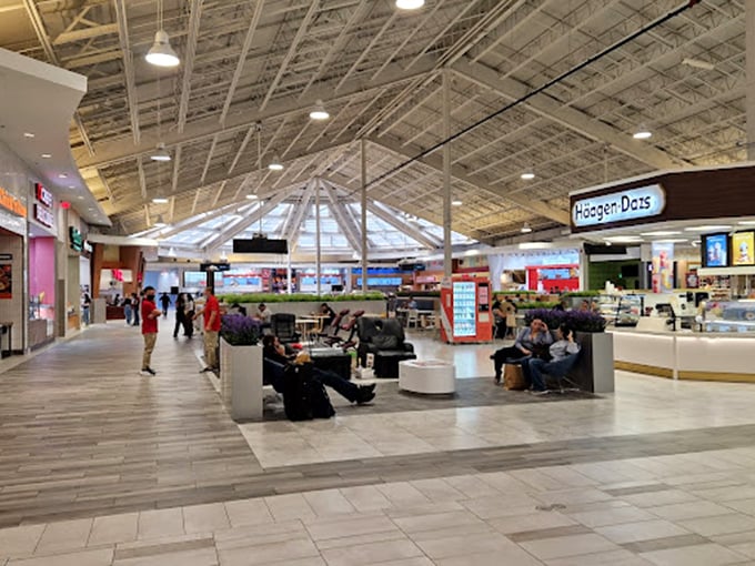 The food court's seating area: where shopping marathoners come to refuel and husbands pretend they're not calculating how many more stores they can endure.