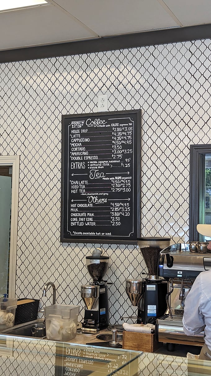 Coffee and pastry: civilization's most perfect pairing. The menu board reveals a thoughtfully curated selection of beverages to complement your buttery indulgence.
