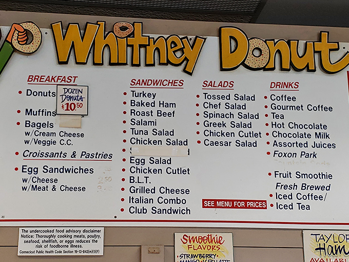 The menu board at Whitney Donut reads like a love letter to comfort food classics, no fancy descriptions needed.