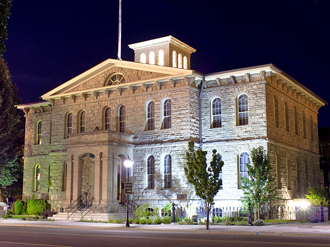 The Nevada State Museum illuminates after dark, its sandstone walls telling stories of silver booms and frontier dreams.