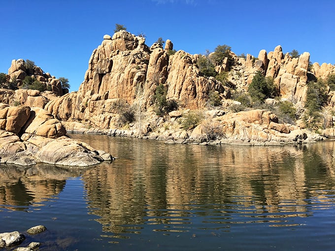 The Granite Dells at Watson Lake create nature's mirror. These ancient rock formations reflect in crystal waters, offering million-dollar views at public park prices.