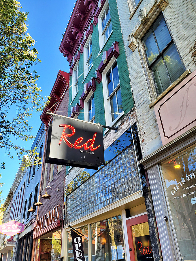 Red on Main's neon sign glows against historic brick, promising sophisticated dining that would feel at home in any big city.