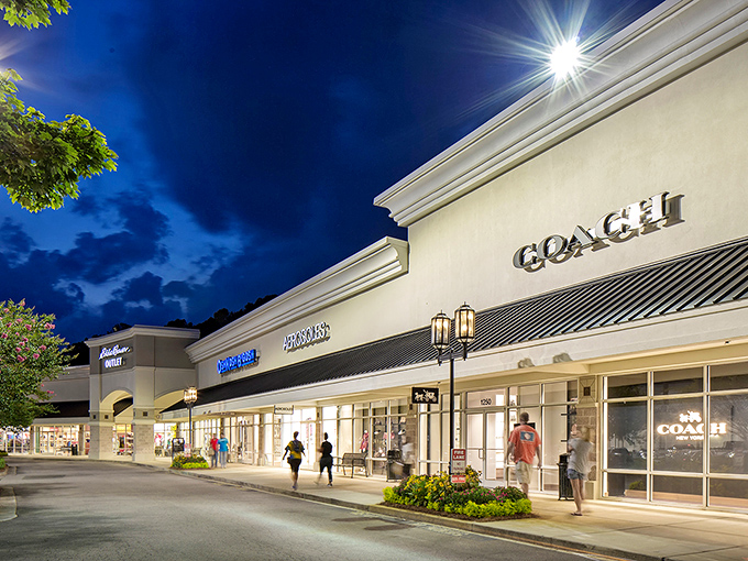 Evening shopping takes on a magical quality with Coach's illuminated storefront beckoning like a beacon for luxury lovers.