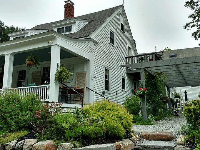 Twin Elm Farm offers that quintessential New England charm with a side of lush greenery. The front porch practically whispers, "Come sit a spell."