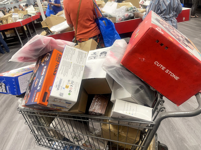 A shopper's cart tells the true story &ndash; this haul includes everything from kitchen gadgets to electronics. The retail equivalent of winning a game show sweep.