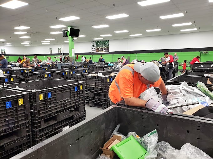 The green room buzzes with the energy of discovery. Every shopper bent over a bin is experiencing that universal thrill of the hunt.