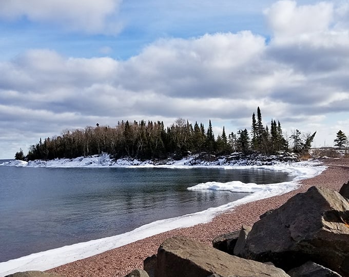 Winter transforms Grand Marais shoreline into a magical borderland where crystalline ice meets Superior's deep blue depths.