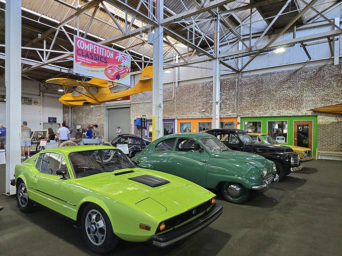A lime-green Saab Sonett sports car sits alongside vintage European classics, like the most eclectic dinner party guests you've ever assembled.