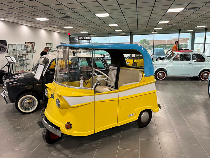 The cheerful yellow Isetta looks like what would happen if a refrigerator and a scooter had an adorable baby. Its front-opening door still delights visitors decades later.