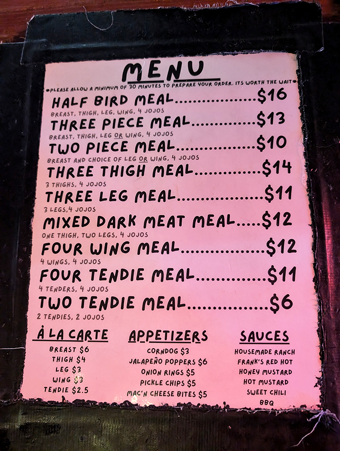 The handwritten pink menu tells you everything you need to know: chicken combinations, jojos, and a friendly warning that perfection takes time.