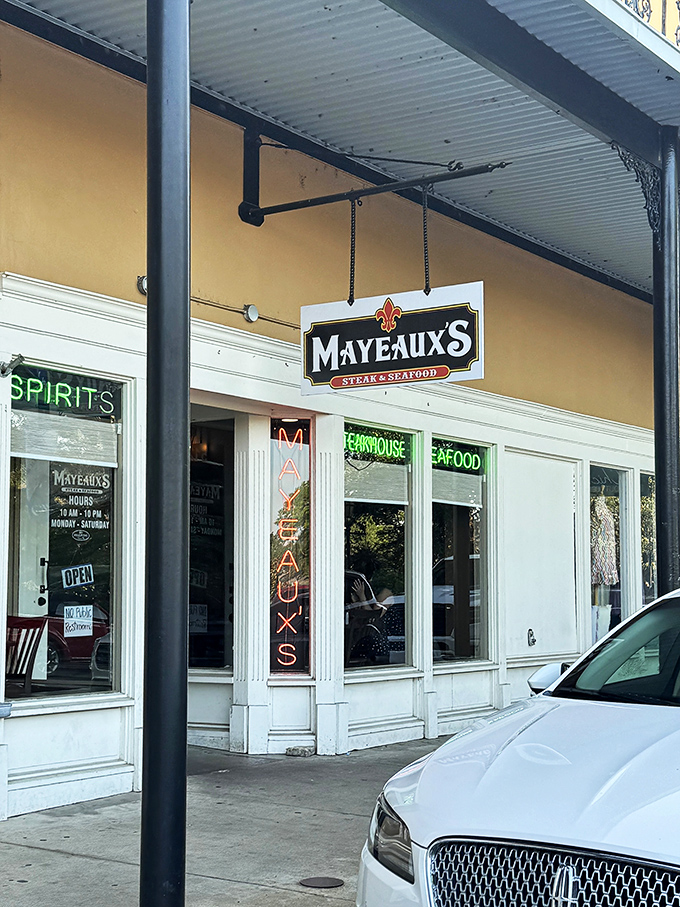 Mayeaux's neon sign glows with promise, a beacon for hungry souls seeking seafood treasures without Manhattan prices. Your taste buds will thank you.