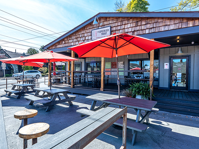 The Speckled Trout's outdoor seating isn't just pandemic-friendly&mdash;it's mountain-air therapy. Those red umbrellas have witnessed more meaningful conversations than most therapists' couches.