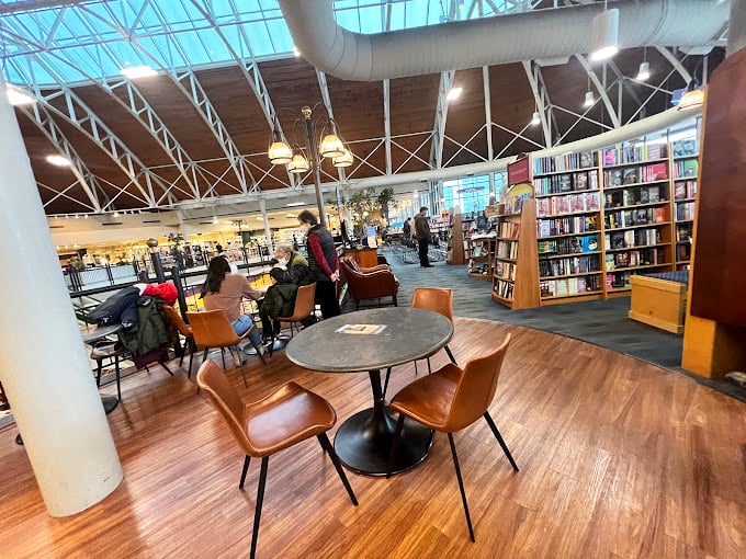 Sunlight streams through the vaulted glass ceiling as you relax in comfortable chairs, surrounded by endless shelves of new adventures.