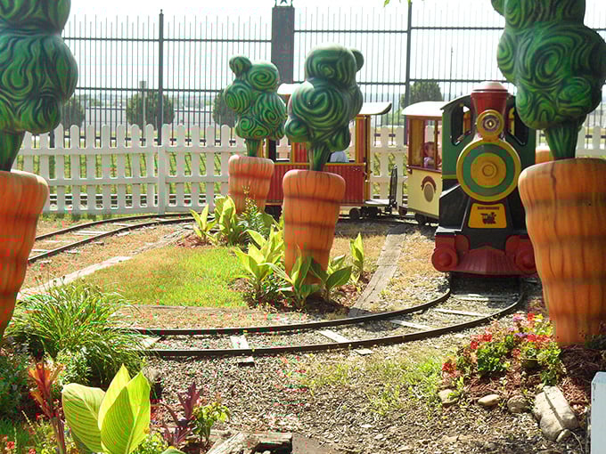 All aboard the whimsy express! This colorful children's train chugs through a garden of cartoonish carrots and stylized trees, delighting the young and young-at-heart.