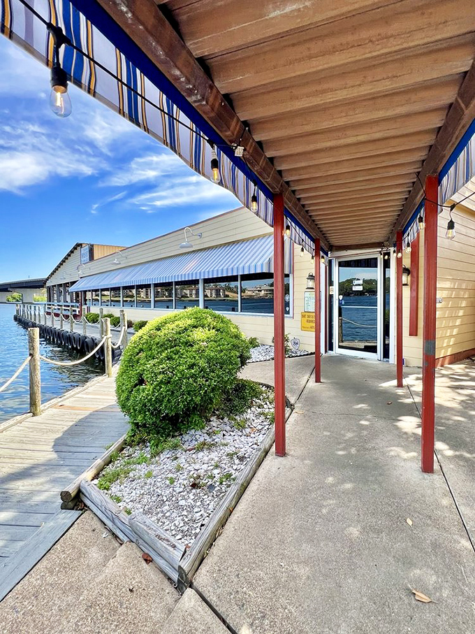 Fisherman's Wharf's lakeside porch isn't just an entrance - it's the gateway to seafood heaven with a side of Arkansas sunset.
