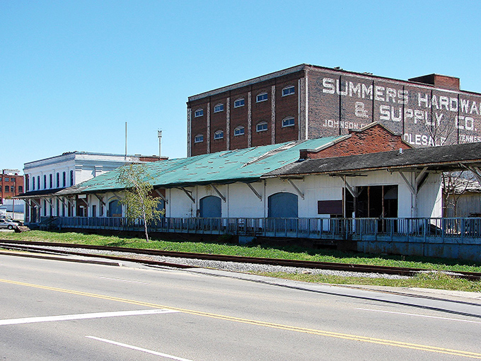 Once a hardware hub, now a quiet relic&mdash;this old warehouse still whispers stories over the railroad hum.