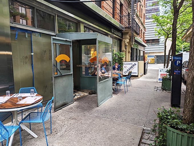 Old John's blue sidewalk seating invites you to pause your city hustle for eggs and conversation.