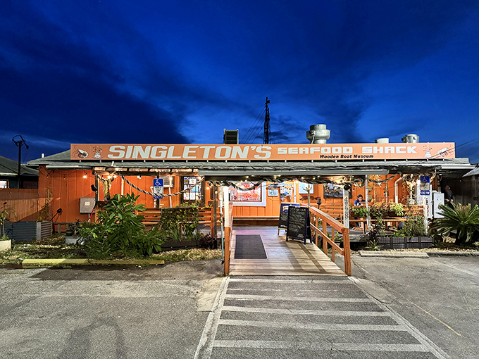 Singleton's orange exterior glows like a sunset against the evening sky. No Instagram filter needed for this authentic seafood shack.