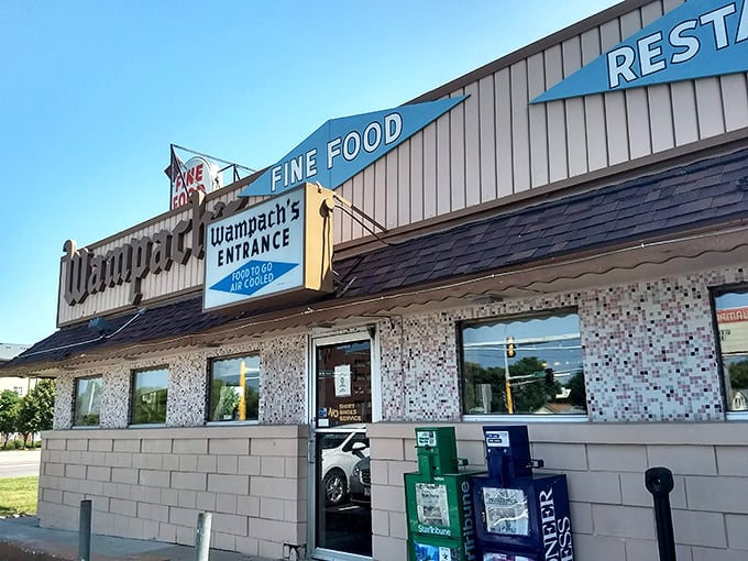 Wampach's exterior daytime: "Fine Food" isn't just a promise on the sign&mdash;it's the reason locals have been filling these booths for generations."