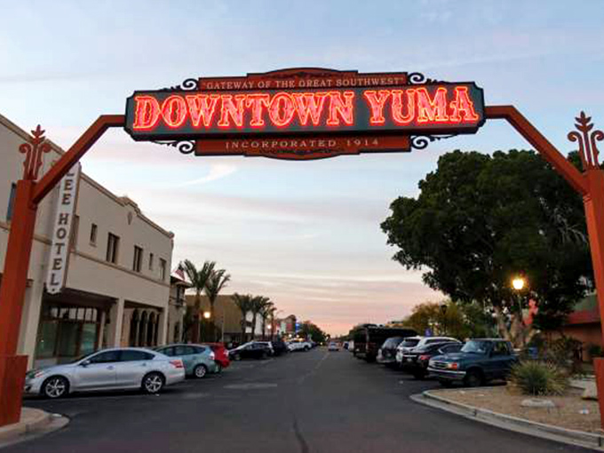 Yuma's historic downtown beckons with its bold gateway sign, promising sunshine and some of Arizona's most affordable living.