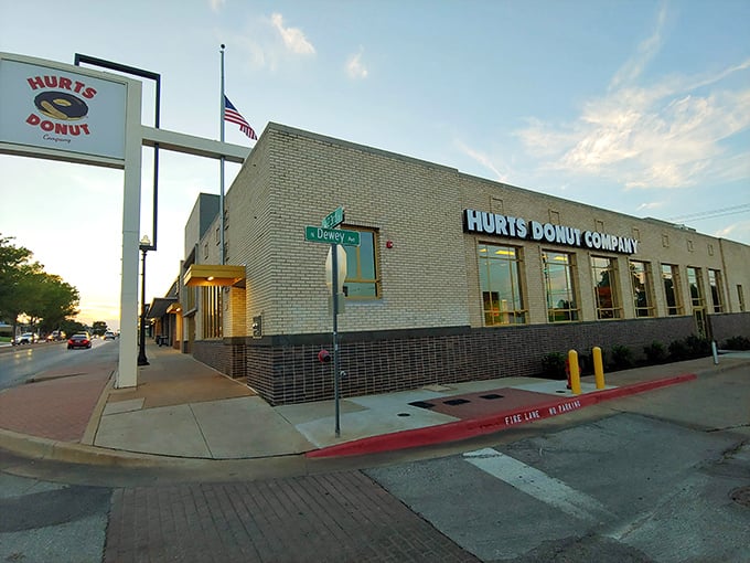 Sunset casts a golden glow on Hurts Donut Company. When the flag flies high, the donuts are fresh&mdash;an American tradition worth saluting.