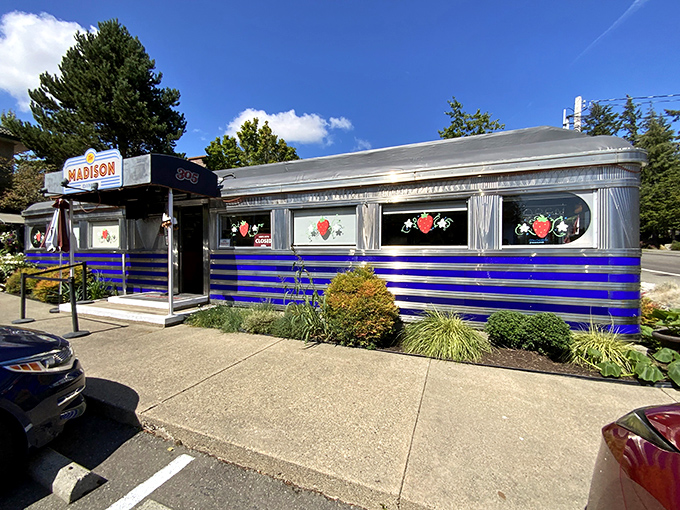 Some diners serve food; this polished blue-striped beauty serves memories wrapped in chrome and nostalgia.