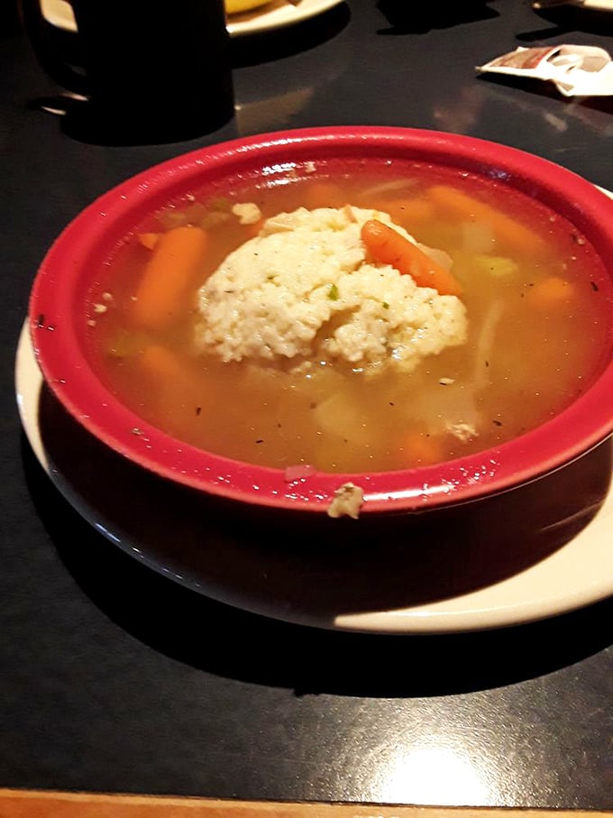 A matzo ball floating like a fluffy cloud in golden broth. This isn't just soup&mdash;it's a warm hug in a bowl.