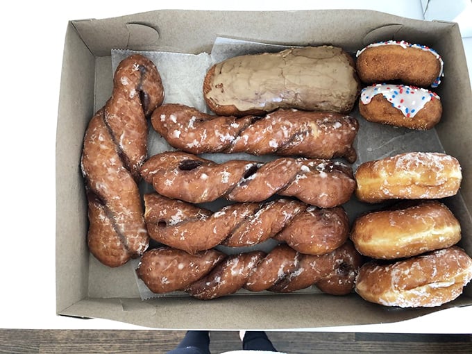 Donut heaven in cardboard form. These twisted beauties and frosted delights aren't just breakfast—they're an edible art form worth setting alarms for.