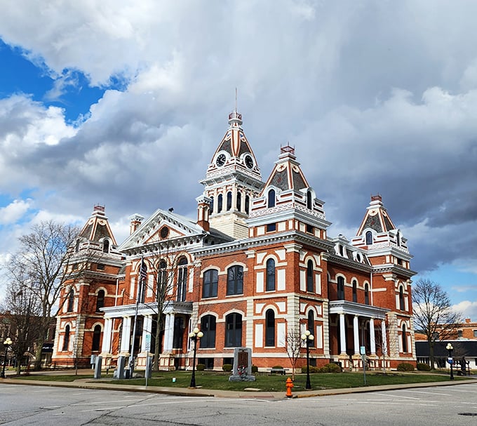 The Livingston County Courthouse rises like a Victorian masterpiece, its ornate towers a reminder of when public buildings were built to inspire, not just house paperwork.